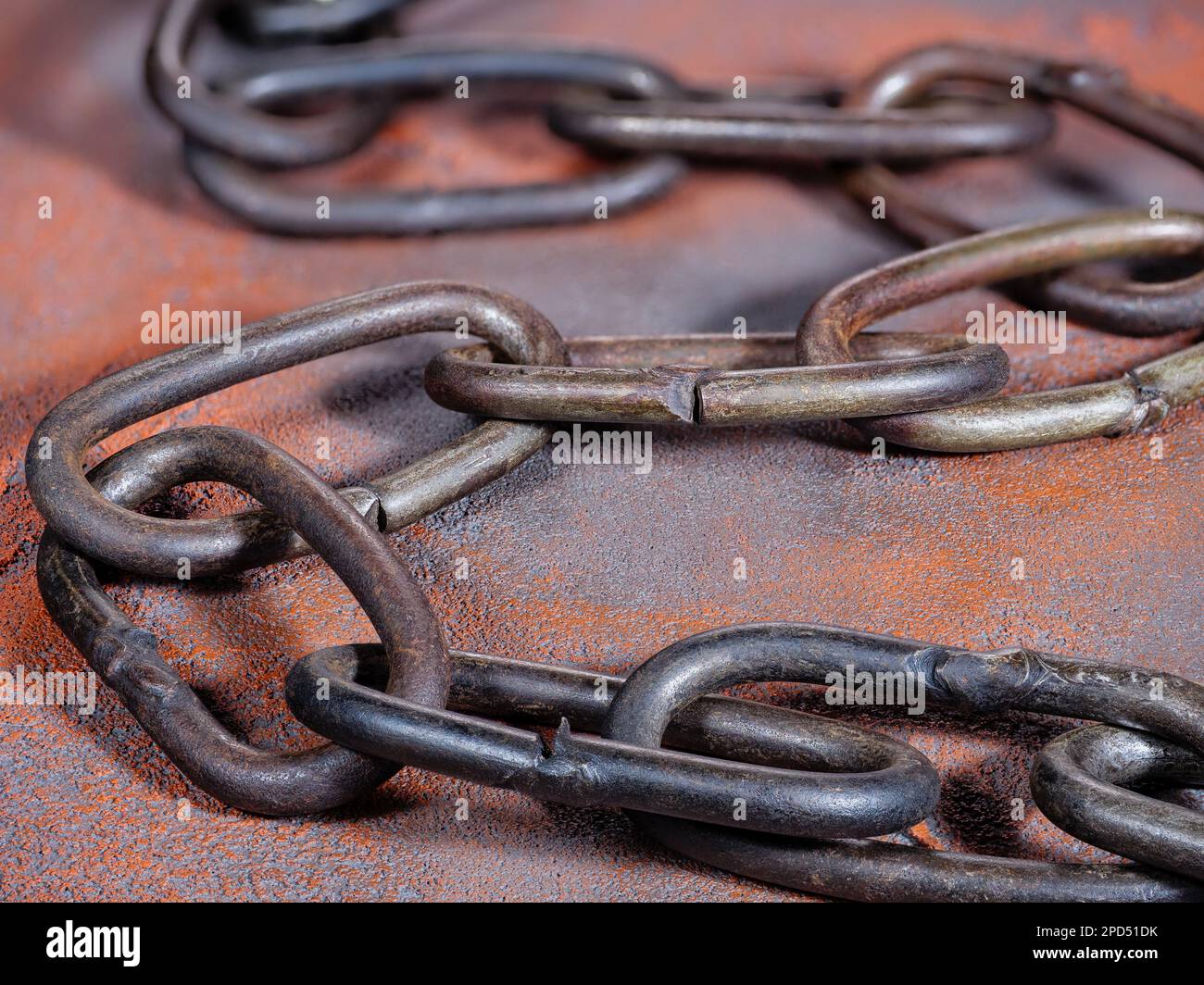Old rusty link chain on an orange grunge background Stock Photo - Alamy