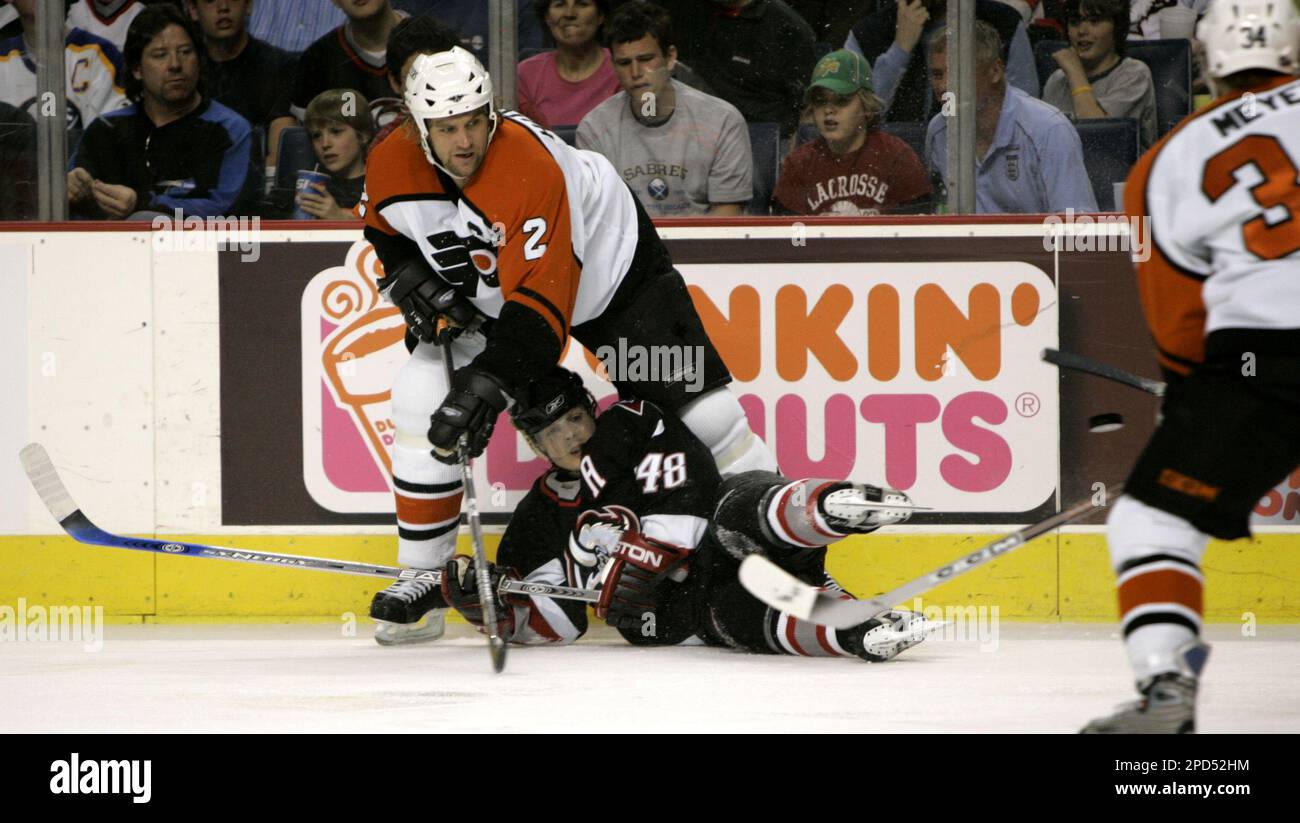 Buffalo Sabres' Daniel Briere (48) is checked to the ice as ...