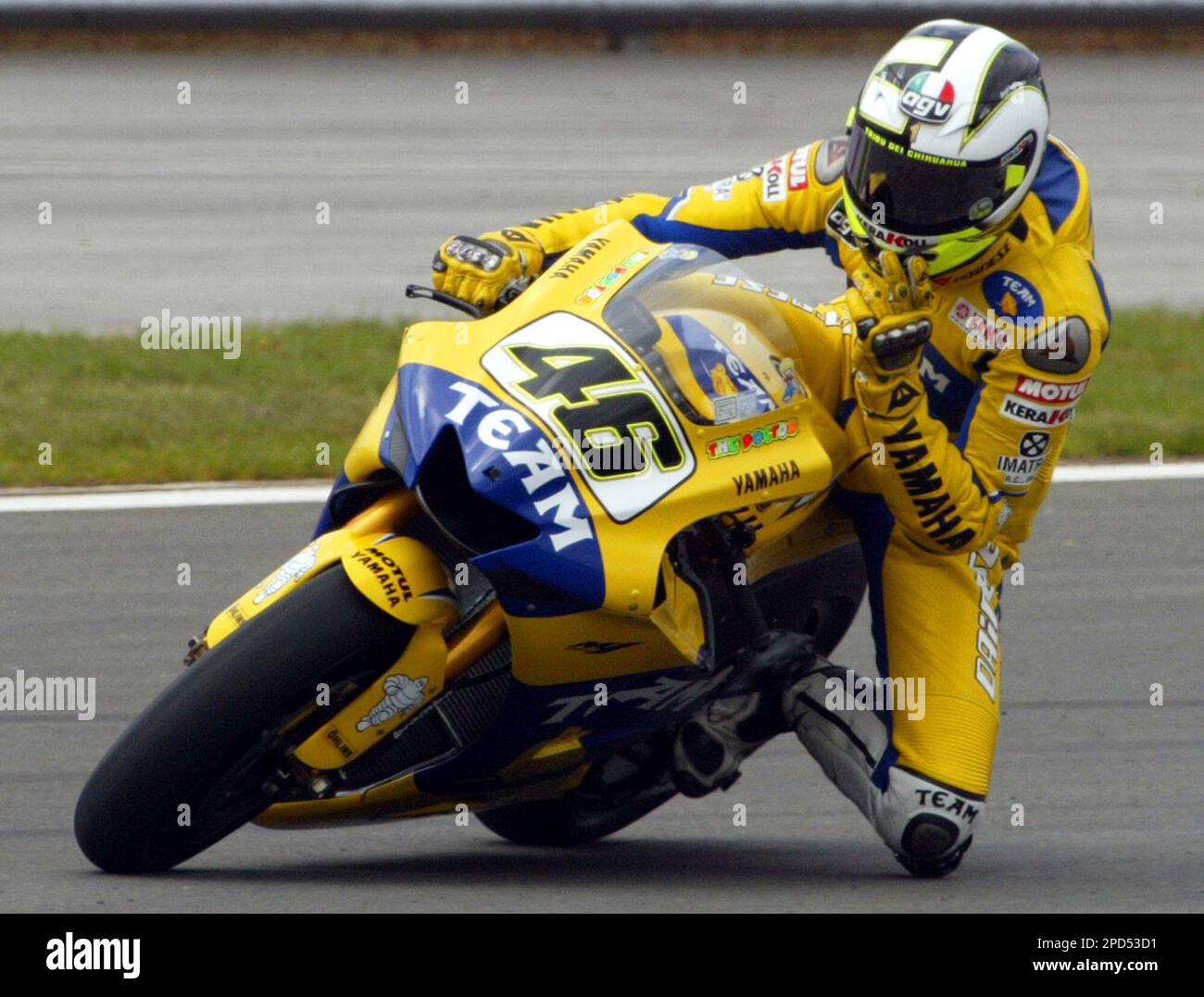Camel Yamaha Team Moto GP rider Valentino Rossi of Italy adjusts his ...