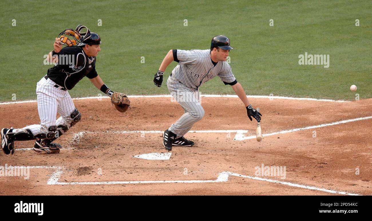 Florida Marlins' catcher Matt Treanor, left, gives chase on a bunt from ...