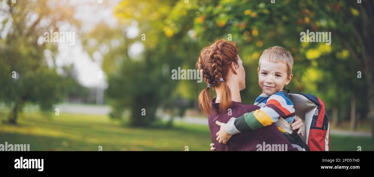Mother meeting her son from primary school Stock Photo - Alamy