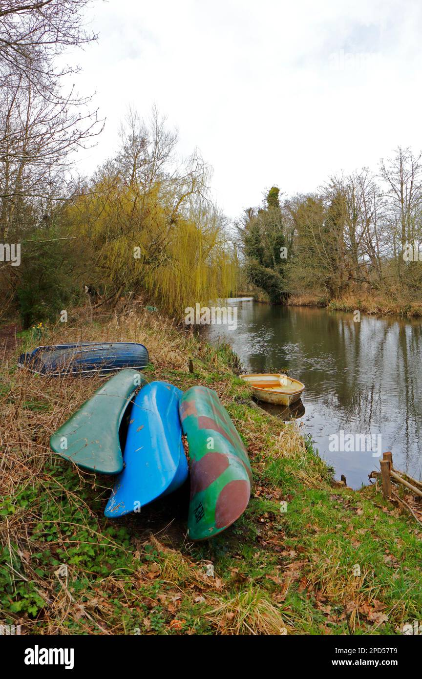 Canoes on the river bank at the upper reaches of the River Bure by the ...