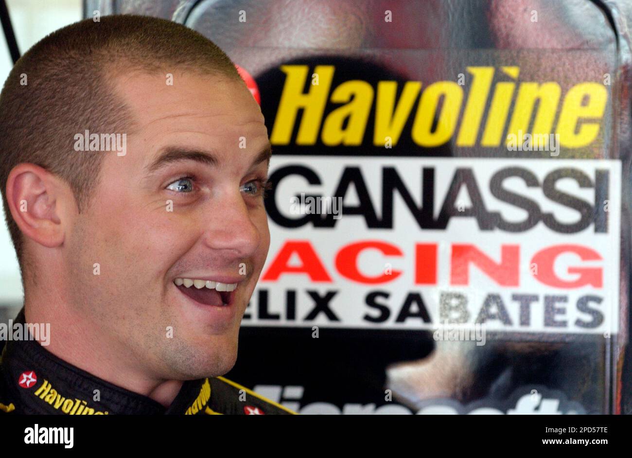 Casey Mears laughs while talking with crew members in the garage area ...