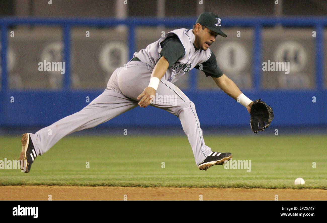 Tampa Bay Devil Rays shortstop Tomas Perez can't reach a ball hit up ...