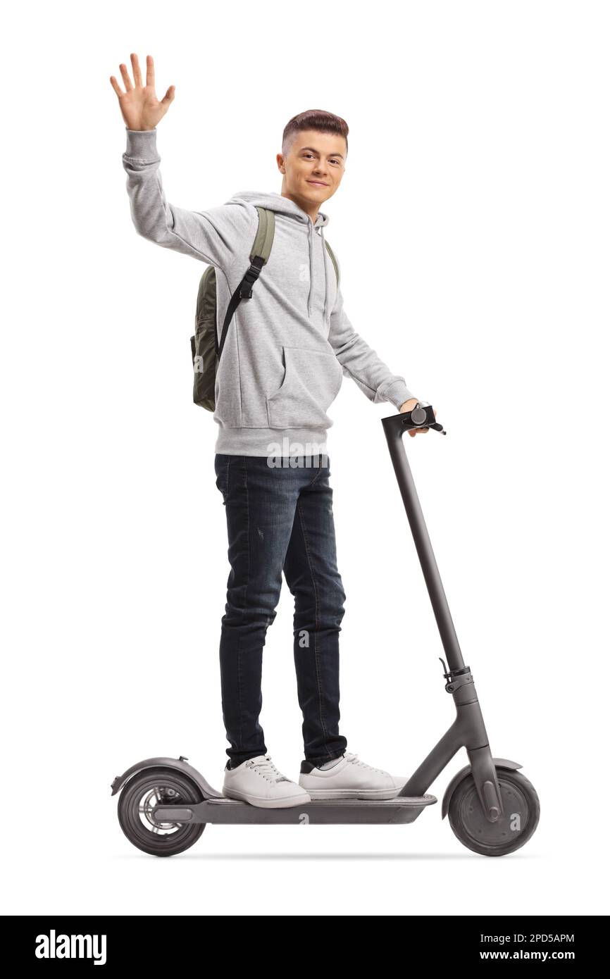 Generation z male riding an electirc scooter and waving at camera ...