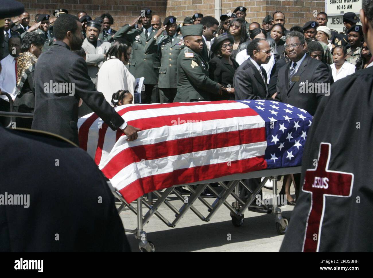 The flag-draped casket of Keith Bender is wheeled outside the New ...