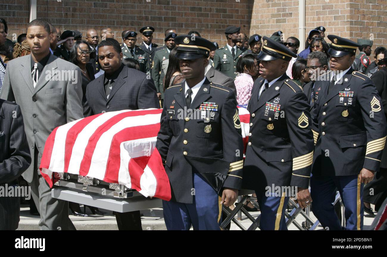 Pallbearers carry the flag-draped casket of Keith Bender to a waiting hearse at the New Galilee ...