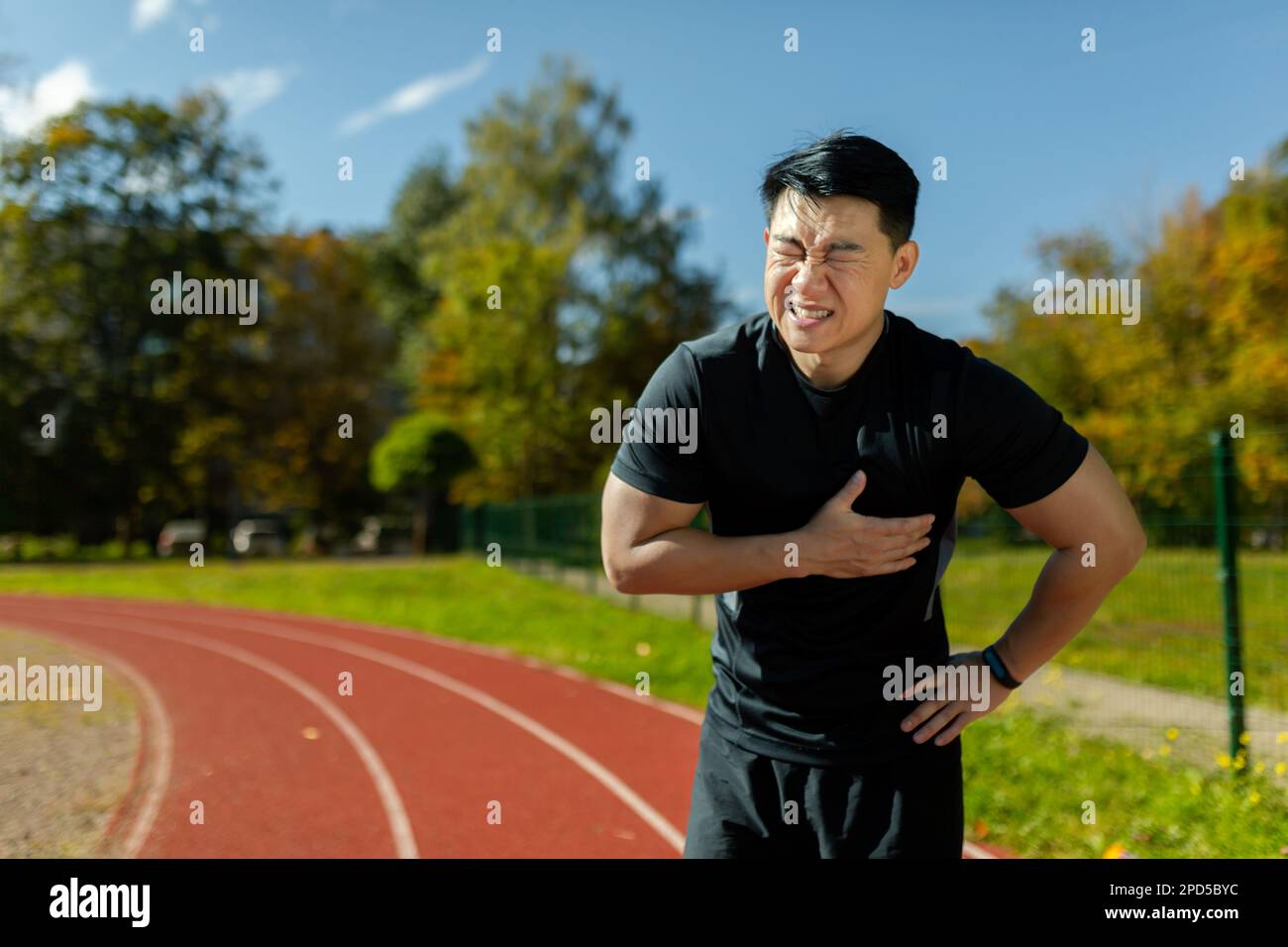 Asian man in sports training has severe heart pain, athlete with heart ...