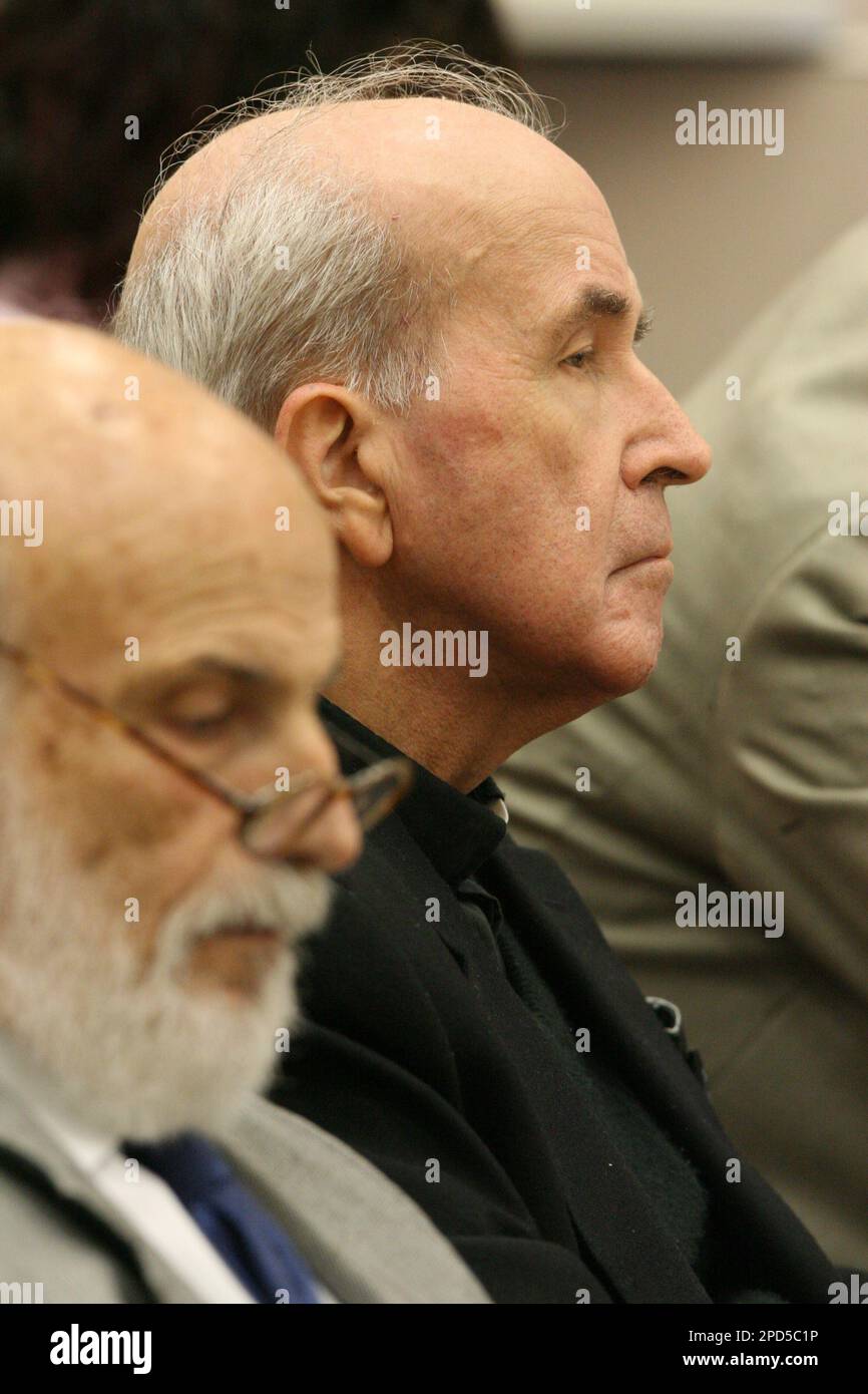 Defense attorney Alan Konop, left, and the Rev. Gerald Robinson listen ...