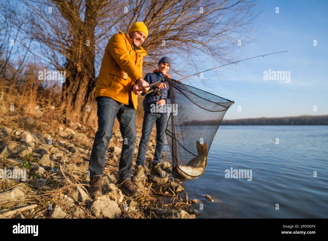 Boy smiling and holding fishing rod hi-res stock photography and images ...