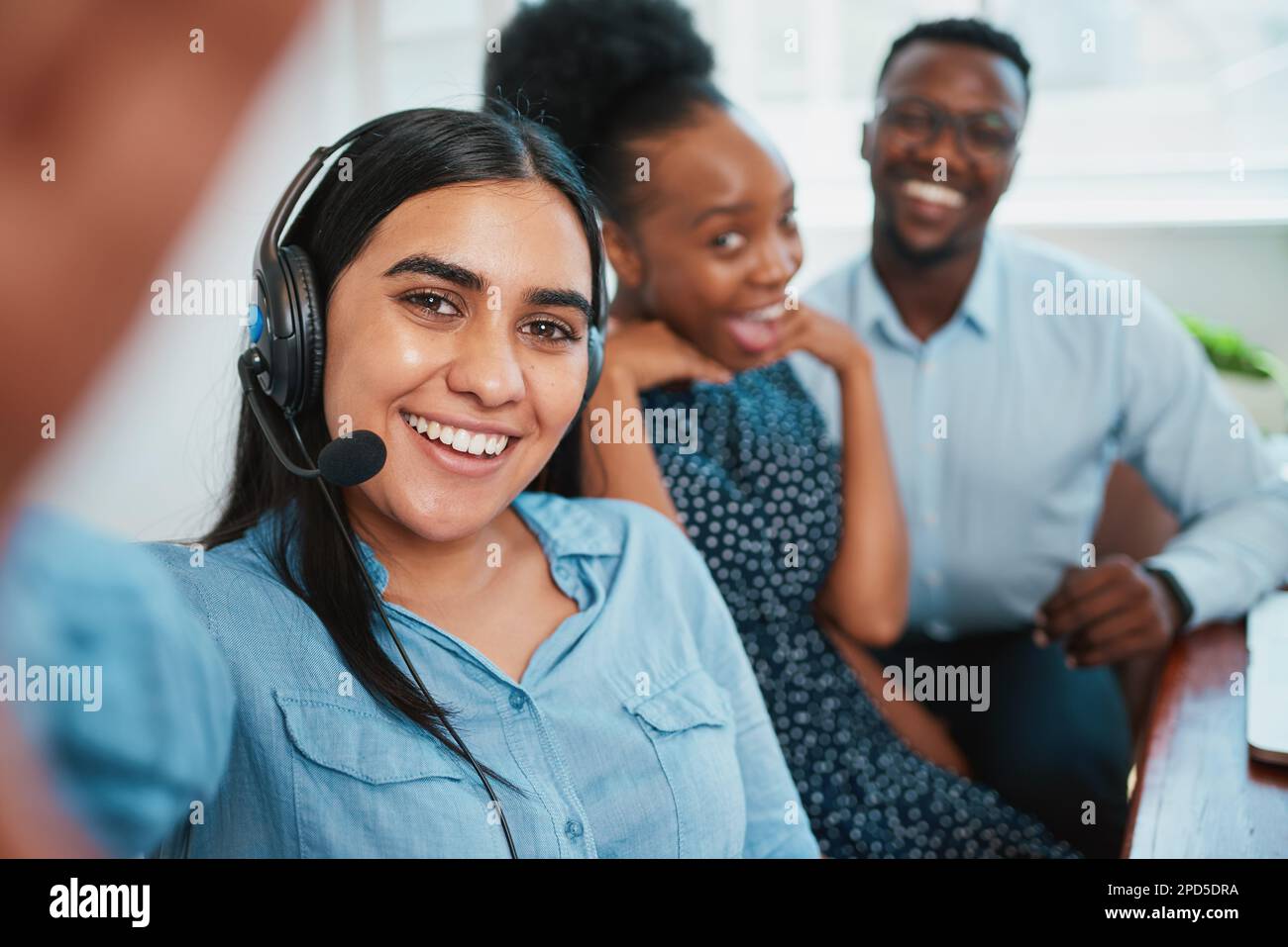 Selfie in the office, call centre agents pose and have fun, teamwork ...