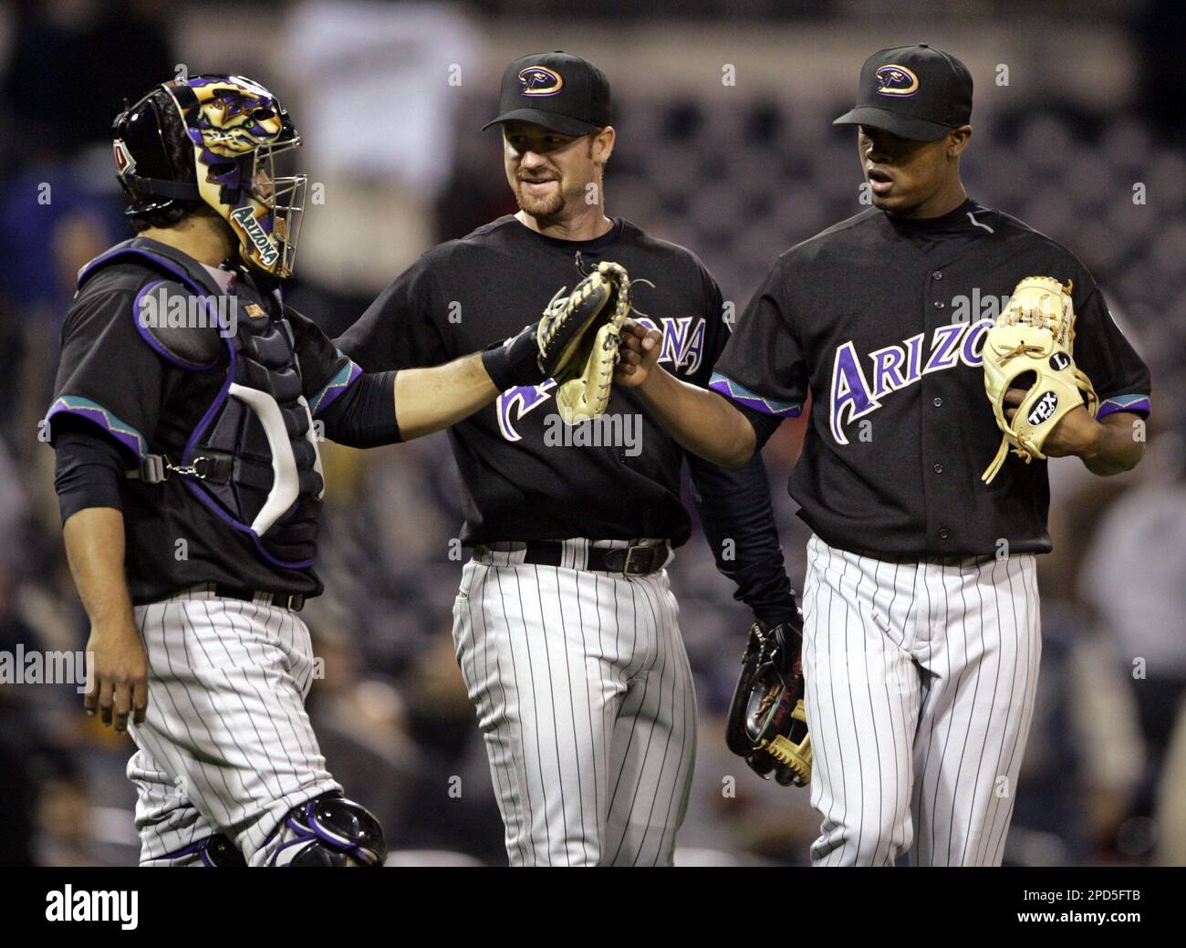 Arizona Diamondbacks' Johnny Estrada, left, Chad Tracy, center, and ...