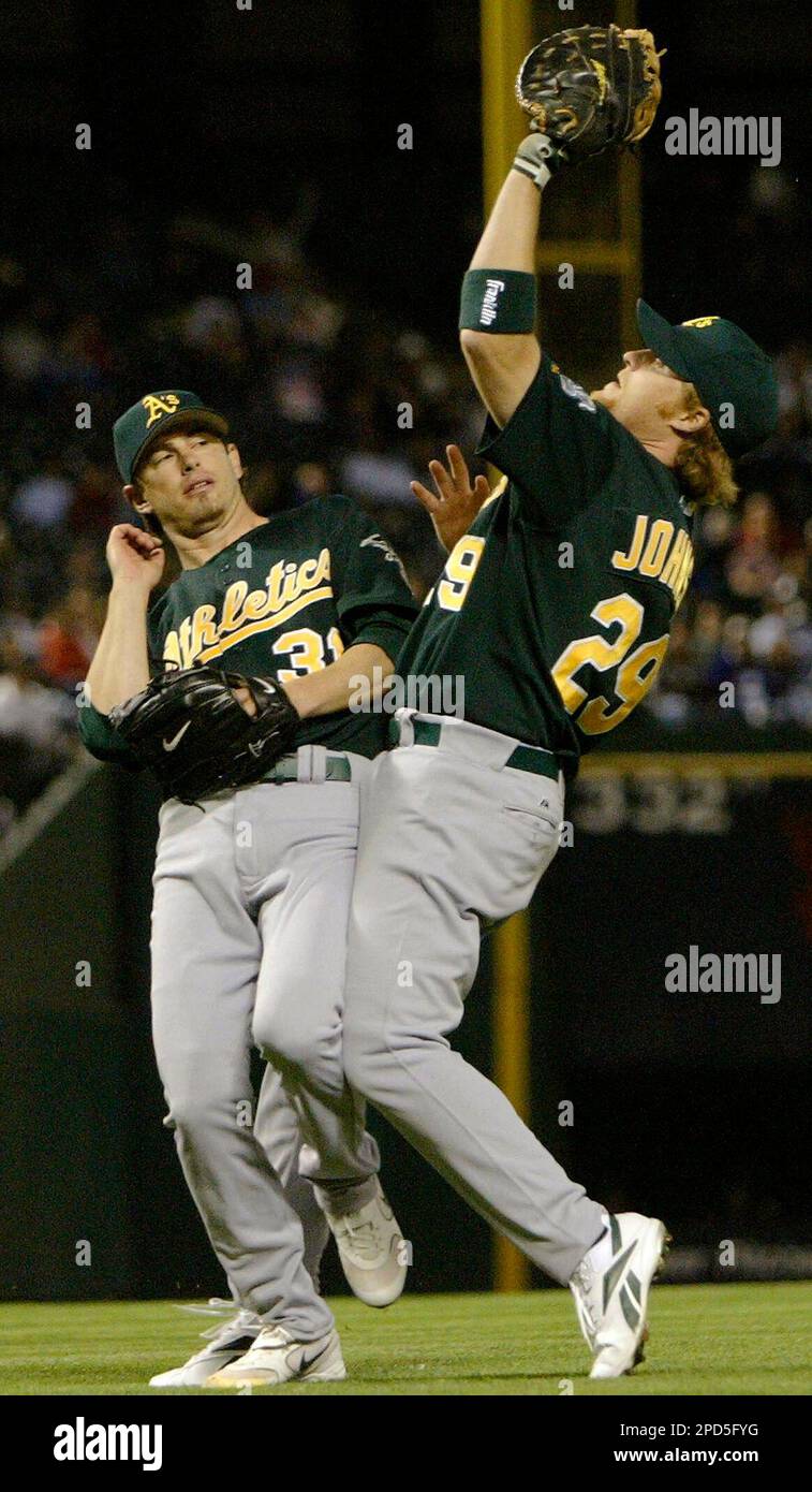 Oakland Athletics pitcher Kirk Saarloos (31) and first baseman Dan ...
