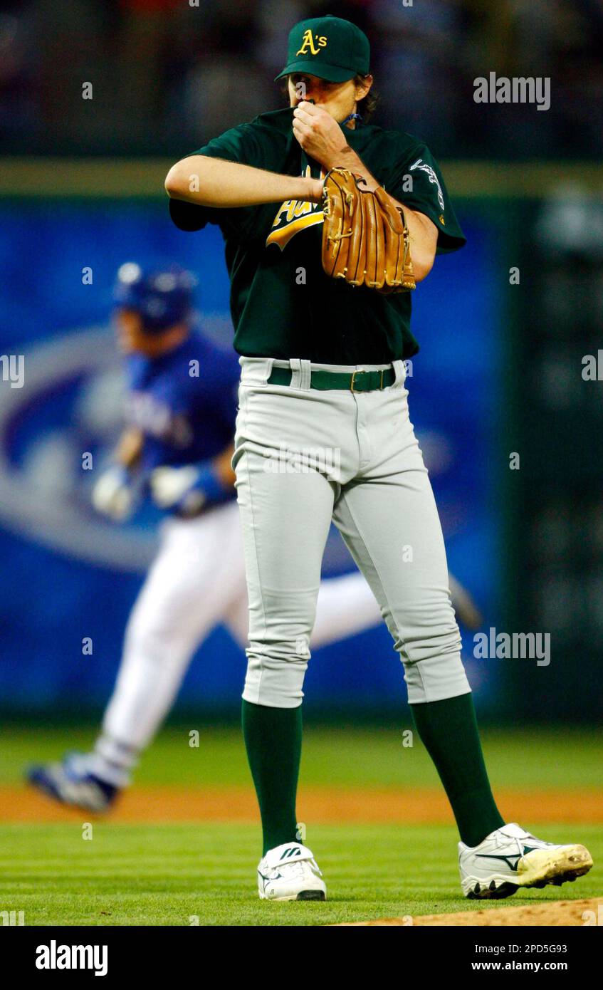Oakland Athletics pitcher Barry Zito wipes his face after giving up a ...