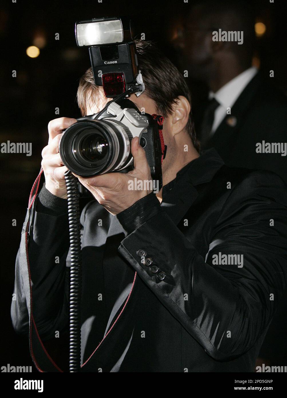 U.S. actor Tom Cruise borrows a photographer's camera to take photos of ...