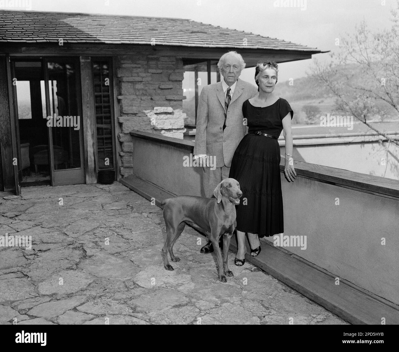 Frank Lloyd Wright, his wife Olgivanna, and their dog Casanova pose outside their home, Taliesen ...