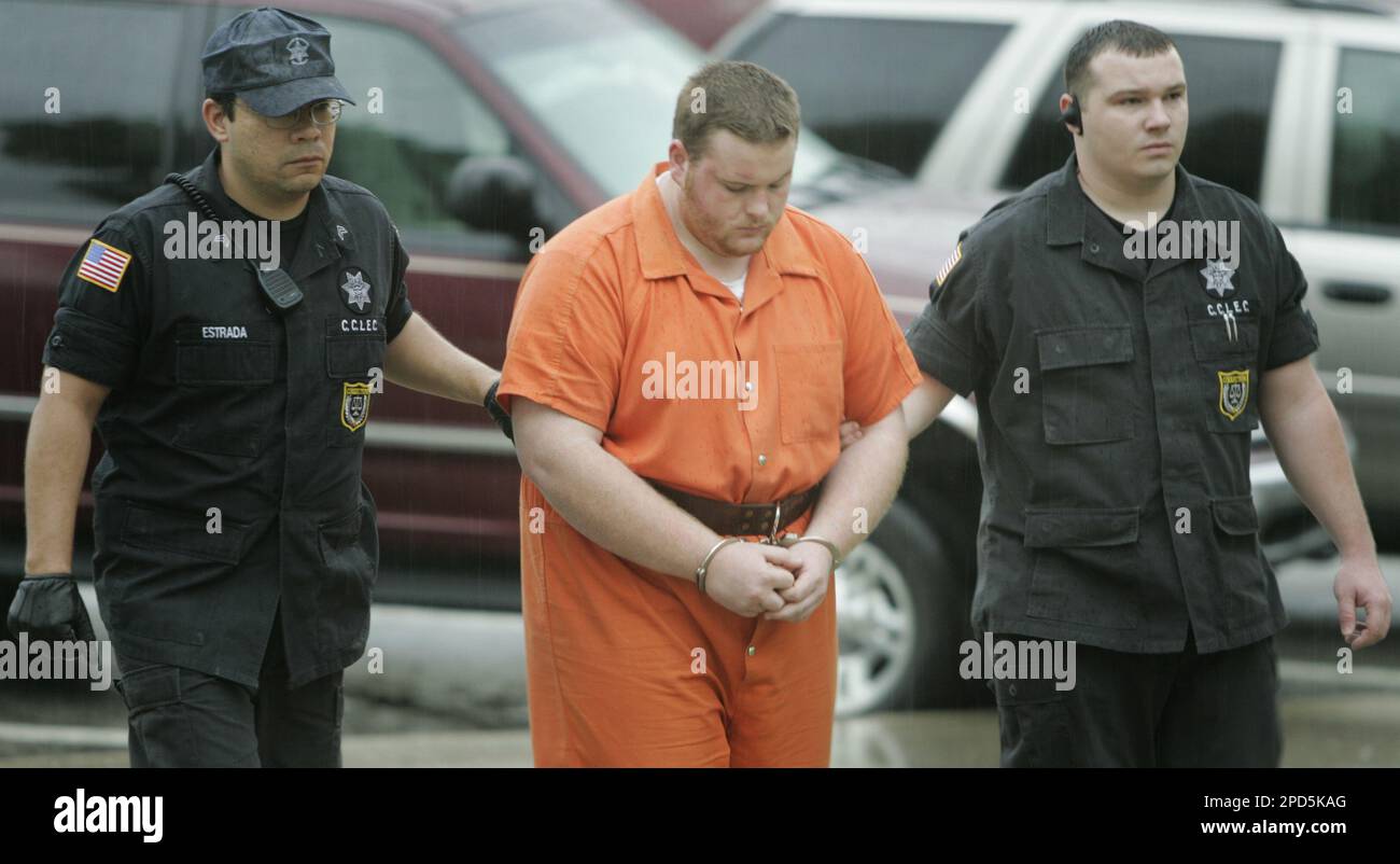 Riverton High School senior Charles "Coy" New, center, is led to a ...