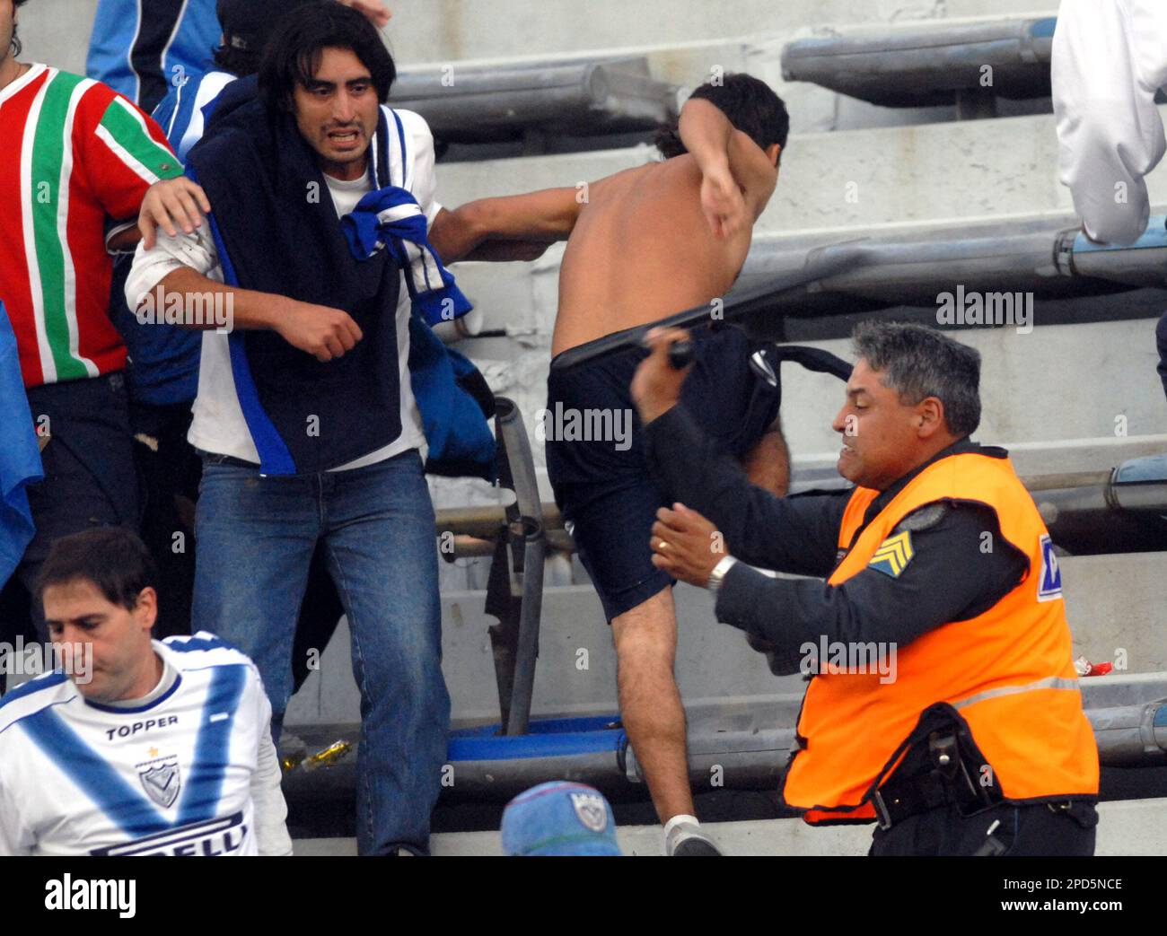 Fans of Velez Sarsfield fights with a policeman, Sunday, April 23, 2006 ...