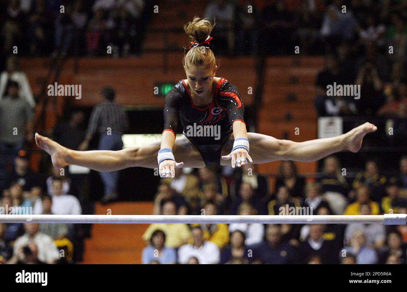 Georgia's Courtney Kupets reaches out for the bar during the uneven ...