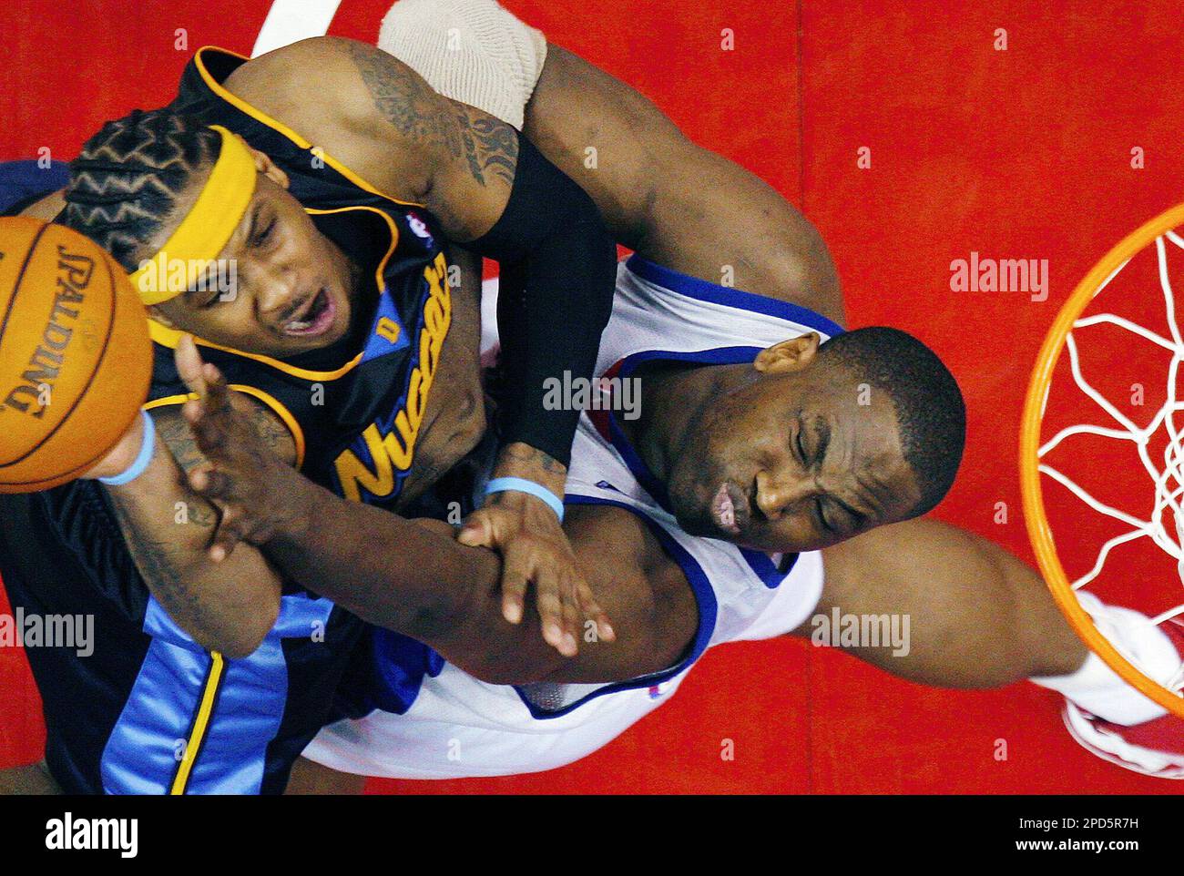 Denver Nuggets' Carmelo Anthony, left, puts up a shot as Los Angeles ...