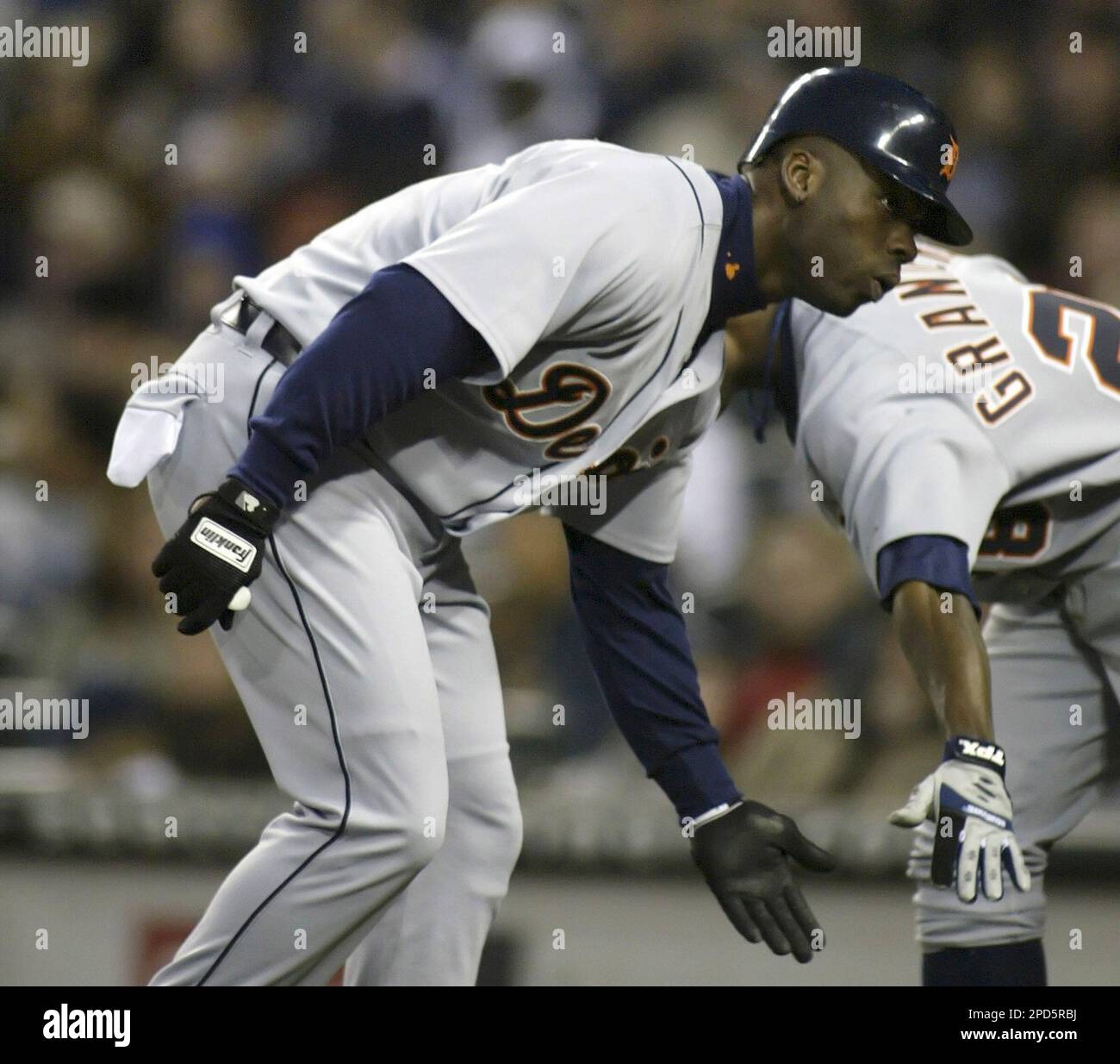 Detroit Tigers' Craig Monroe, left, is low-fived at home by teammate ...