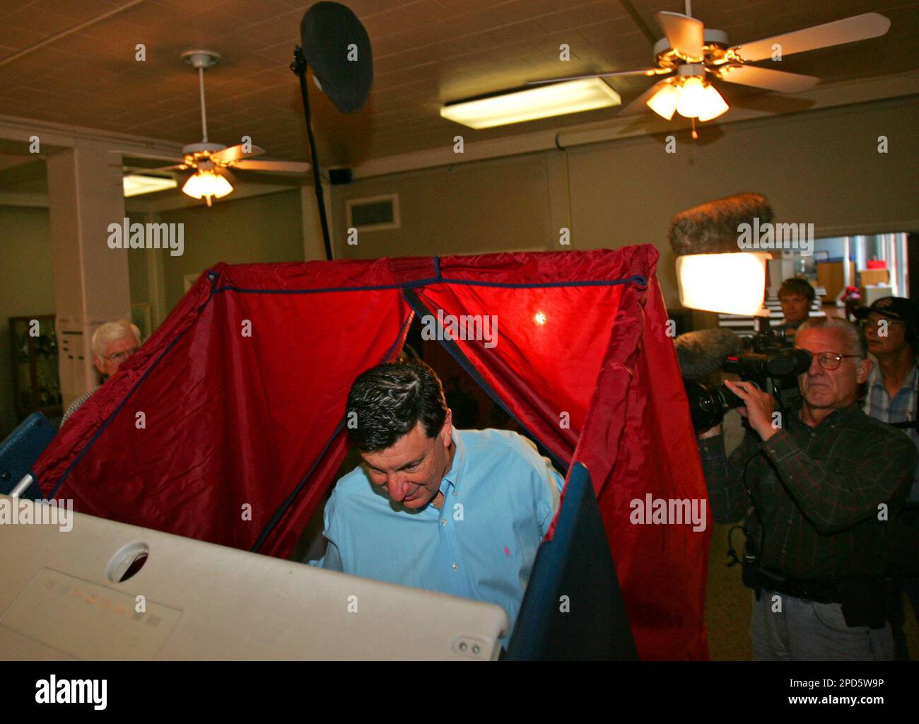New Orleans mayoral candidate Ron Forman enters the voting booth in New ...