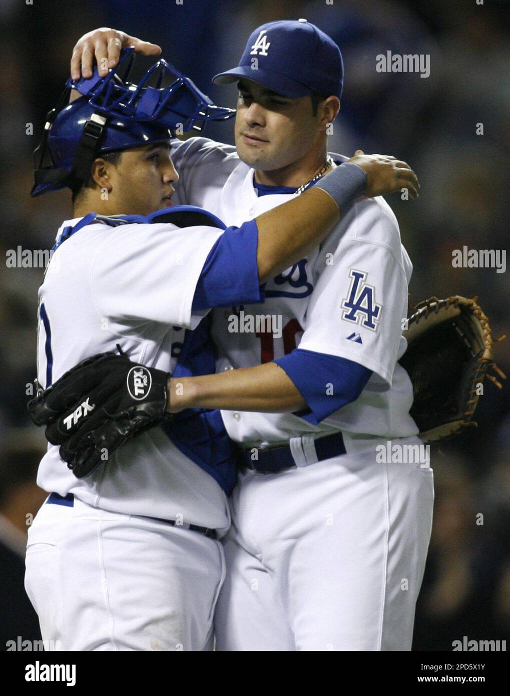 Los Angeles Dodgers pitcher Danys Baez, right, hugs catcher Dioner ...