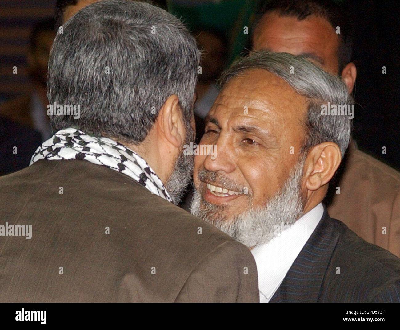 Khaled Mashall, head of the Hamas' political bureau, shakes hands with ...