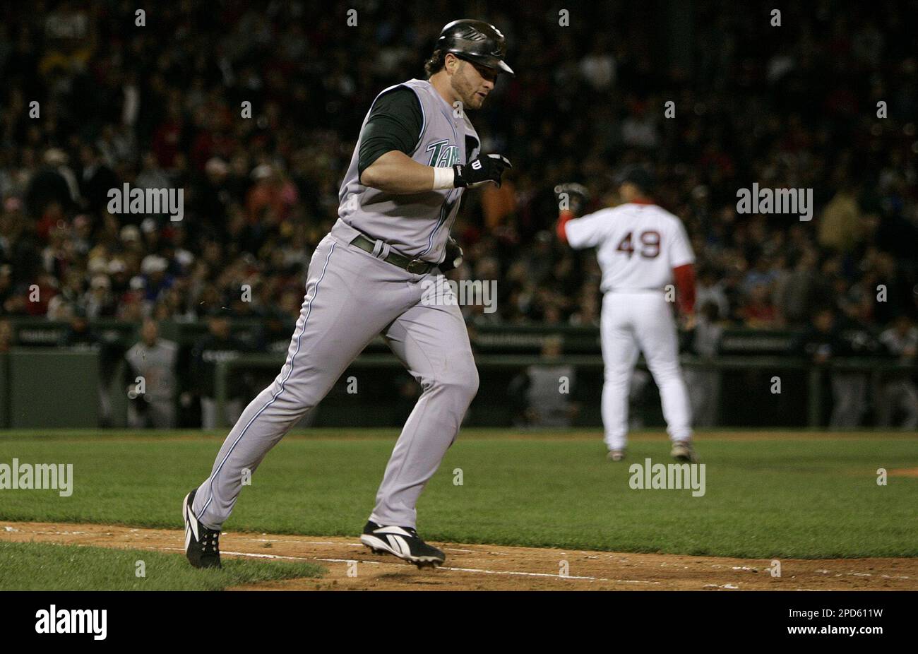 Tampa Bay Devil Rays' Jonny Gomes rounds the bases on his solo home run ...