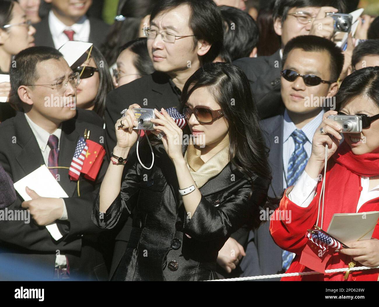 Chinese actress Ziyi Zhang, center, takes photographs during a ceremony hosted by President Bush ...