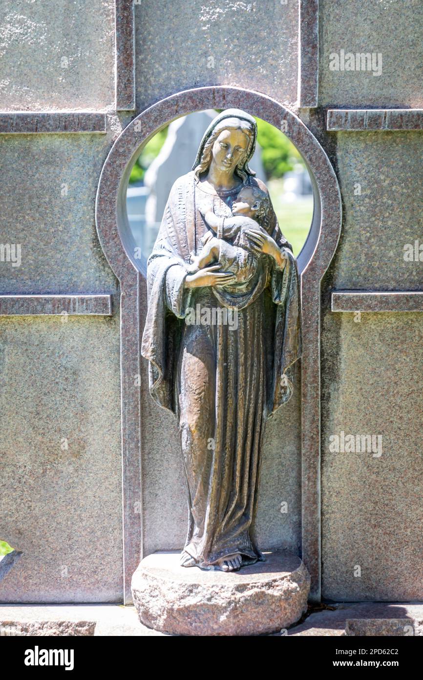 Statue of Baby Jesus in the arms of Virgin Mary on a Catholic headstone ...