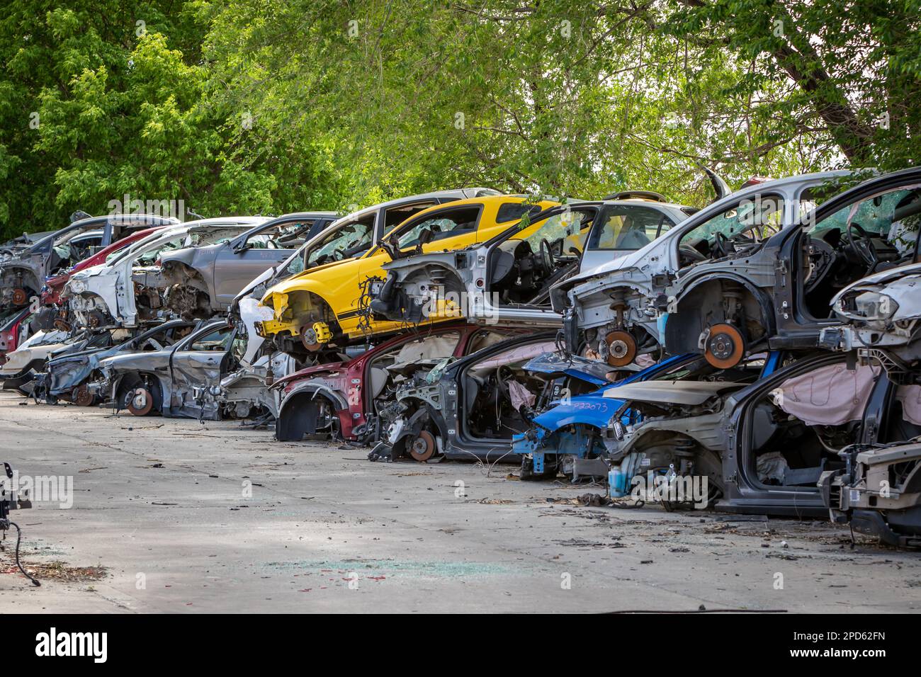 Car part salvage yard with rows of stacked wrecked cars Stock Photo - Alamy