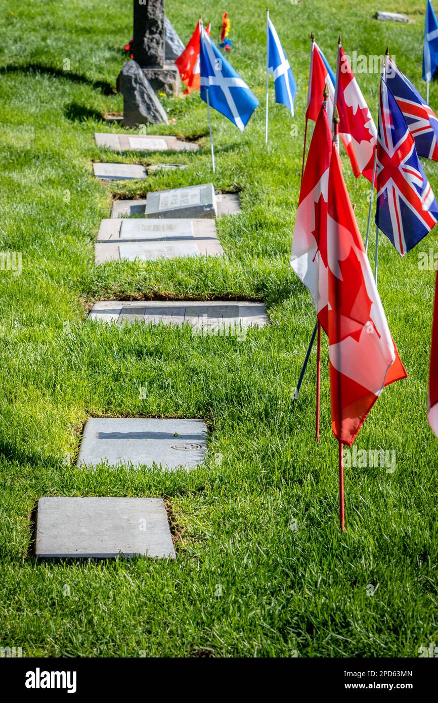 Flags of Canada, Great Britain, and Scotland decorating headstones at a ...