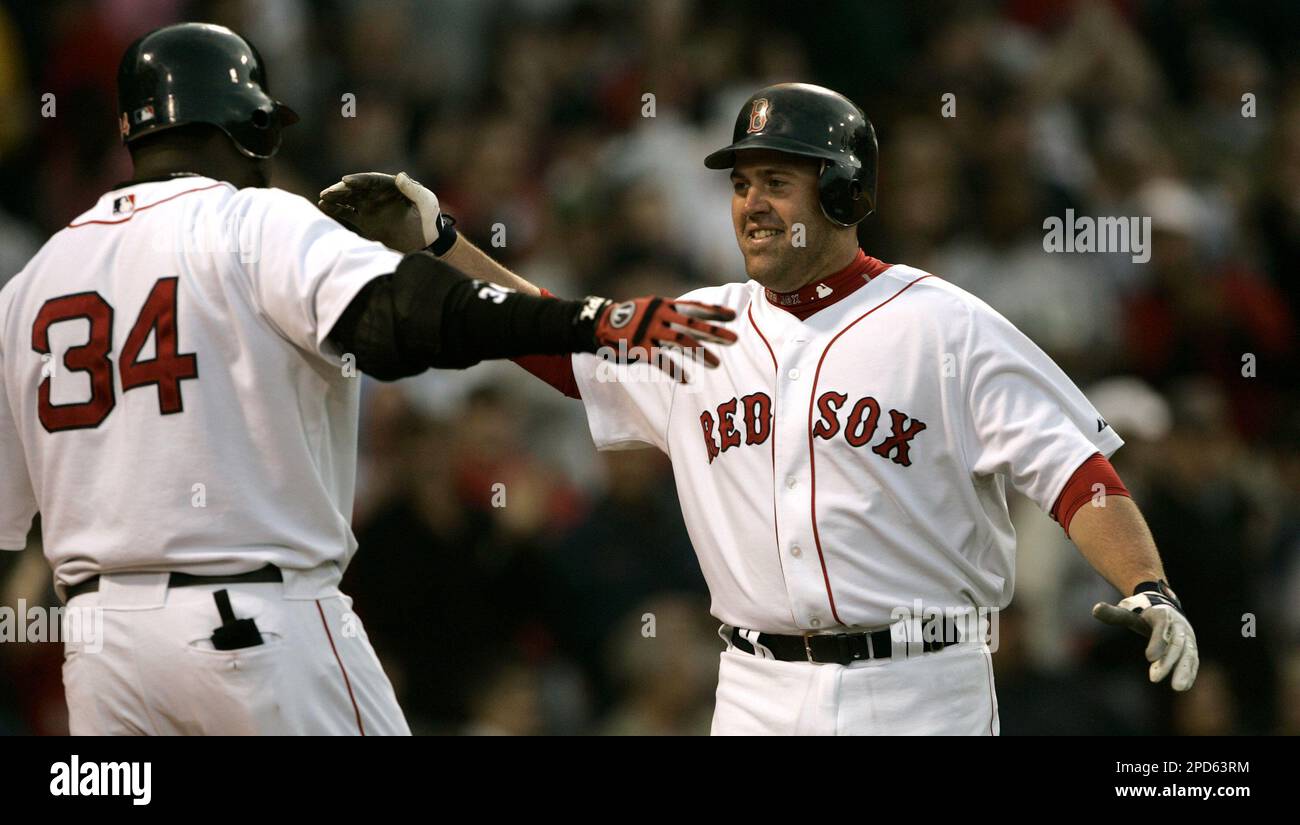 Boston Red Sox's Kevin Youkilis, right, is congratulated by teammate ...