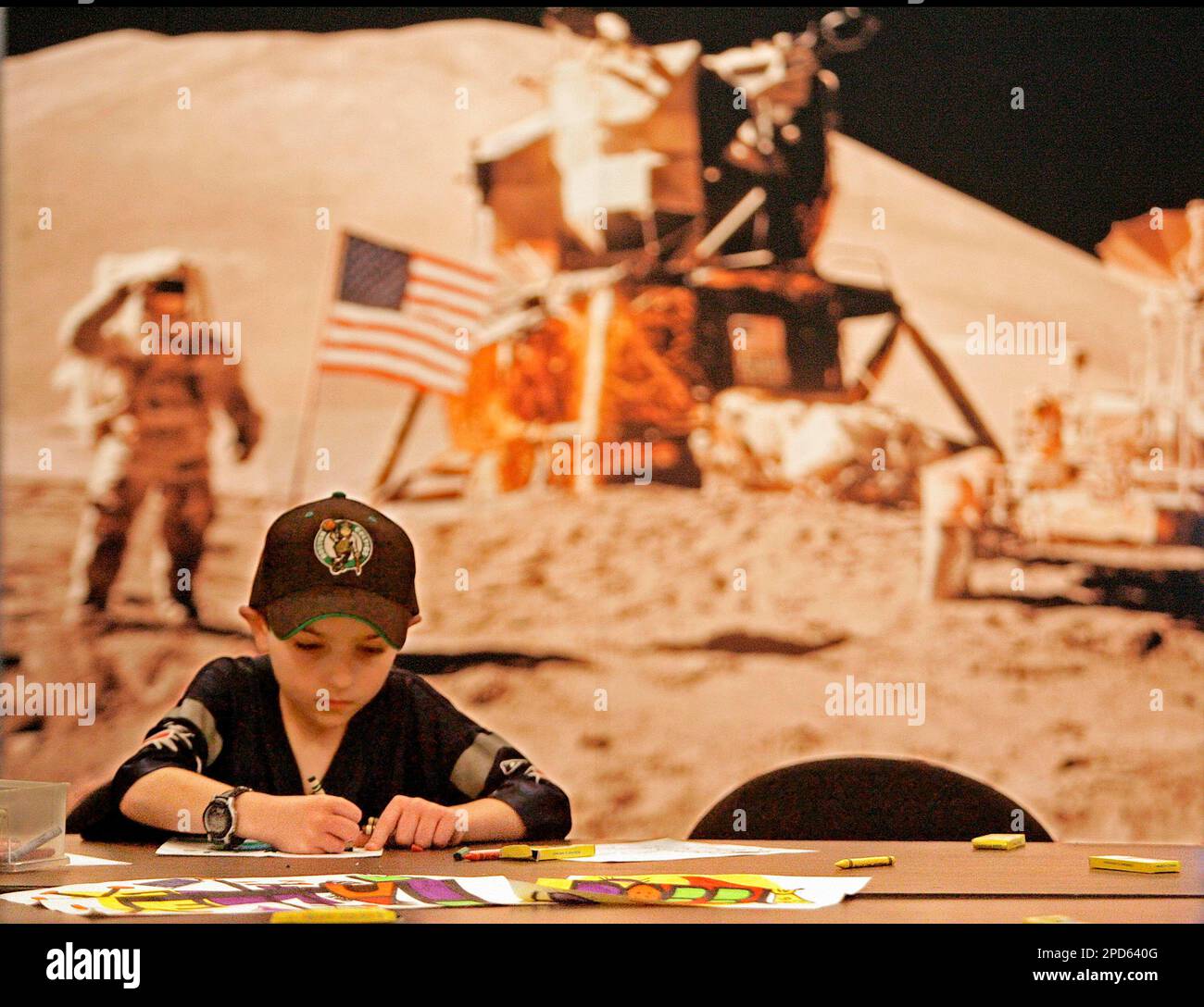 Robbie Papazian, 9, draws a picture of an alien as part of a program ...