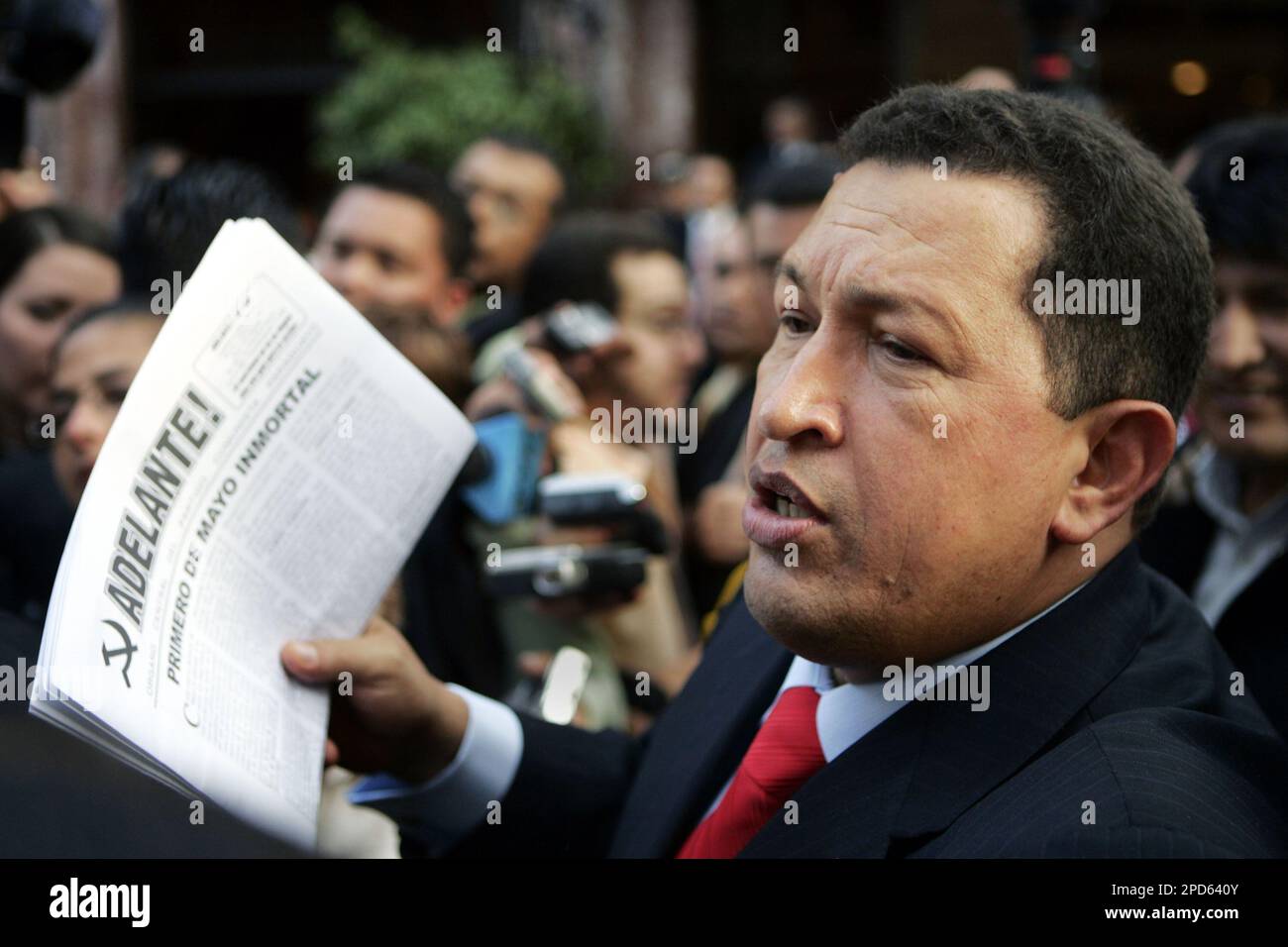 The President of Venezuela Hugo Chavez talks to the crowd holding a ...