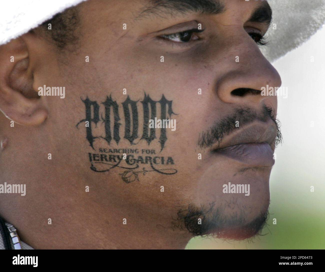 Pierre Johnson, 28, of Detroit shows his rapper Proof tattoo on his ...