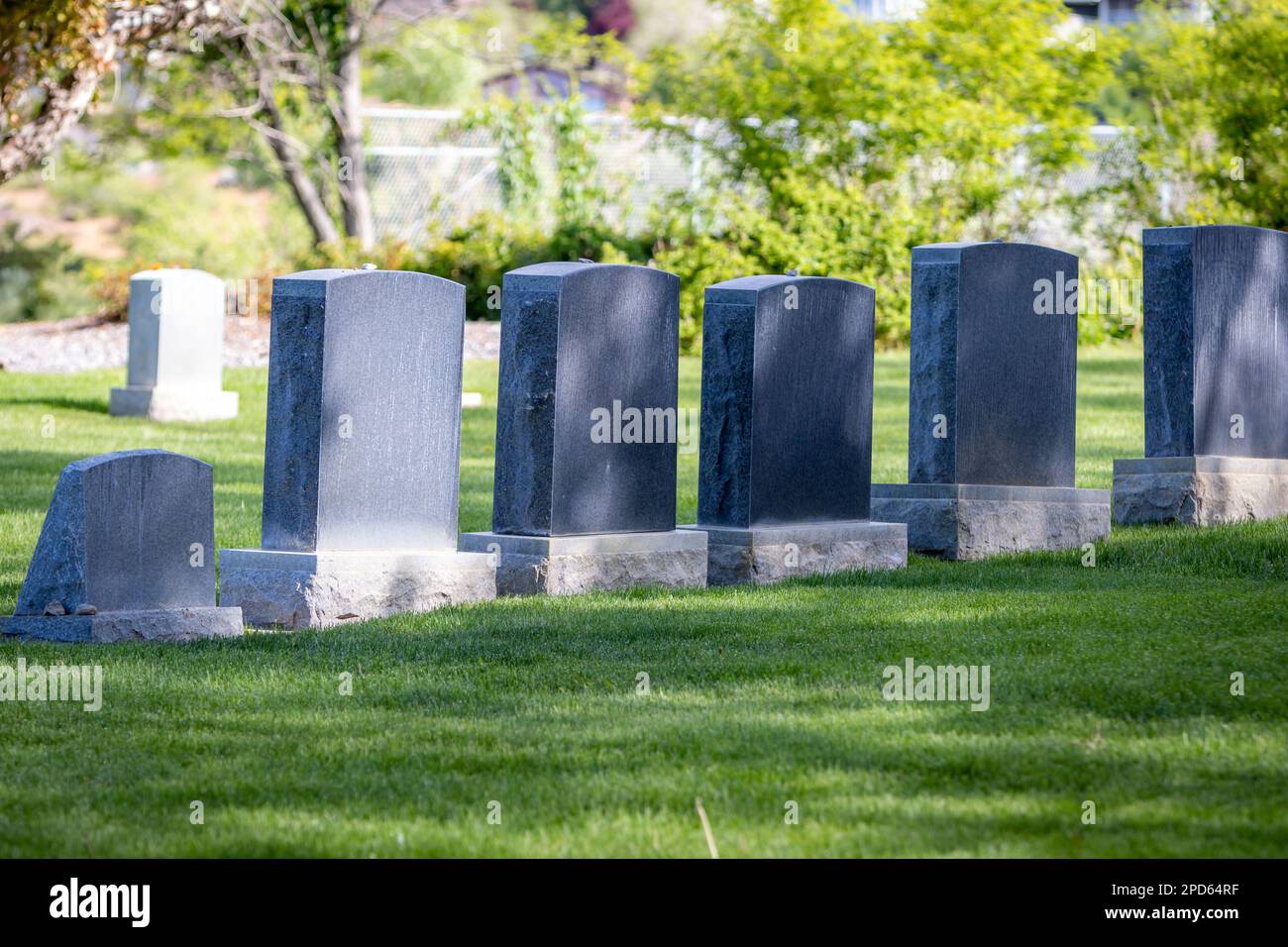 A row of stone grave markers at a cemetery Stock Photo - Alamy