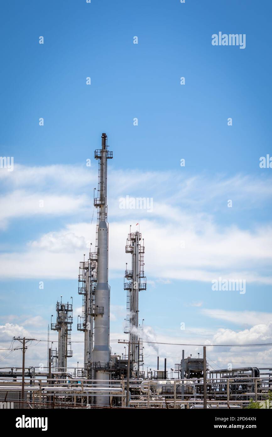 Oil refinery towers against a blue sky with clouds Stock Photo - Alamy