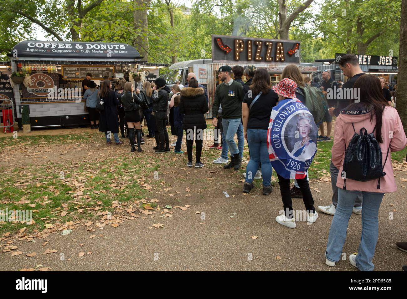 A portrait of the late Queen Elizabeth II is seen in the queue for a ...