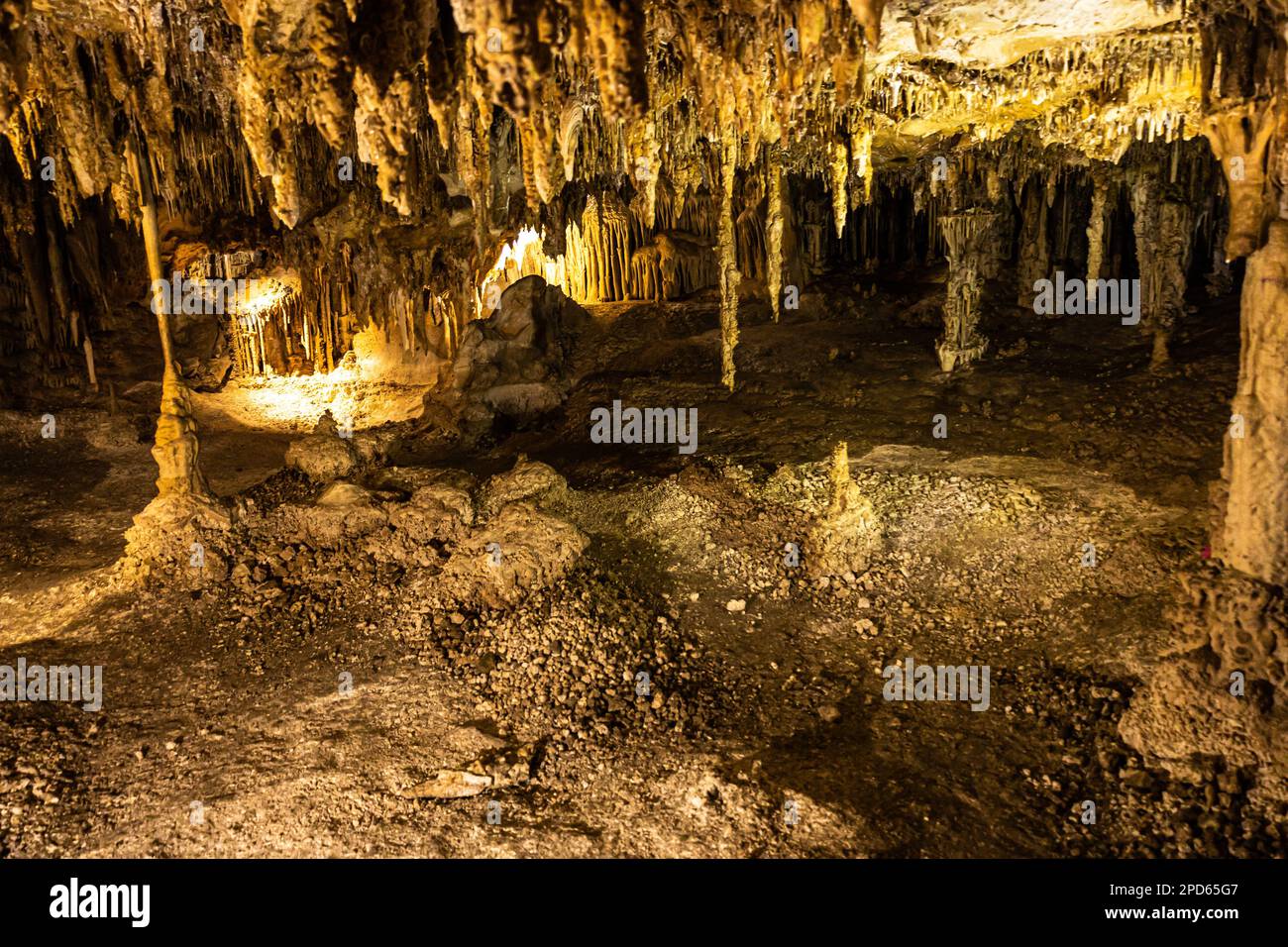 Inside a cave with calcium carbonate rock formation with stalactites ...