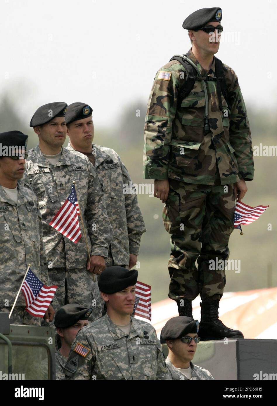 Soldiers wait for the arrival of Vice President Dick Cheney looks at ...