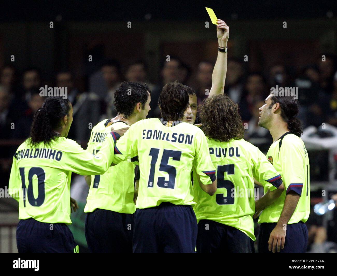 French referee Alan Sars shows a yellow card to Barcelona's Mexican ...