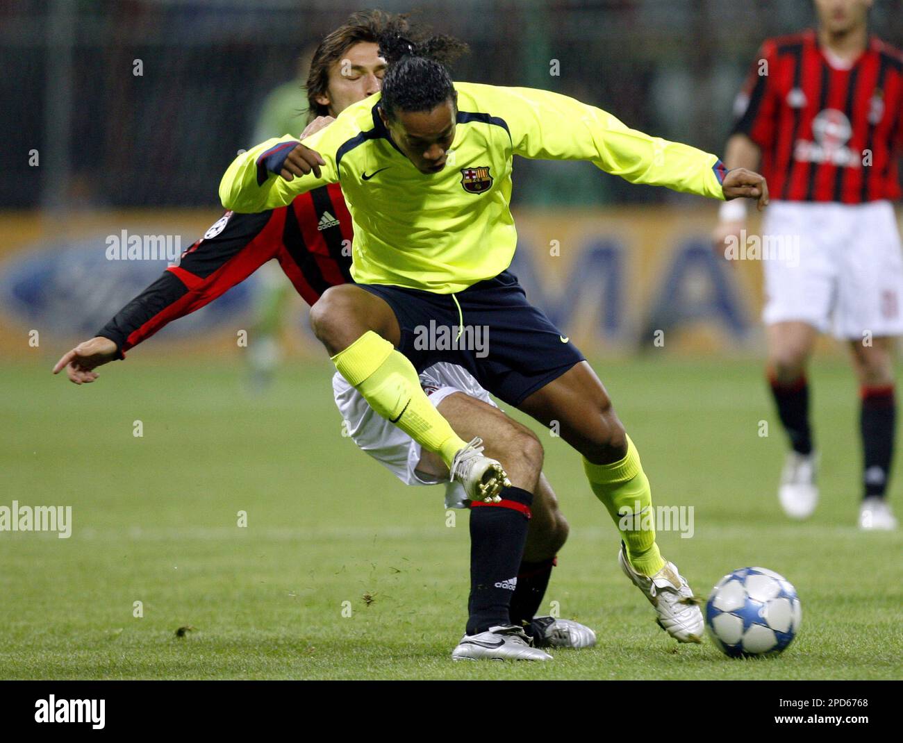 Barcelona's star Ronaldinho of Brazil, right, holds back AC Milan's ...