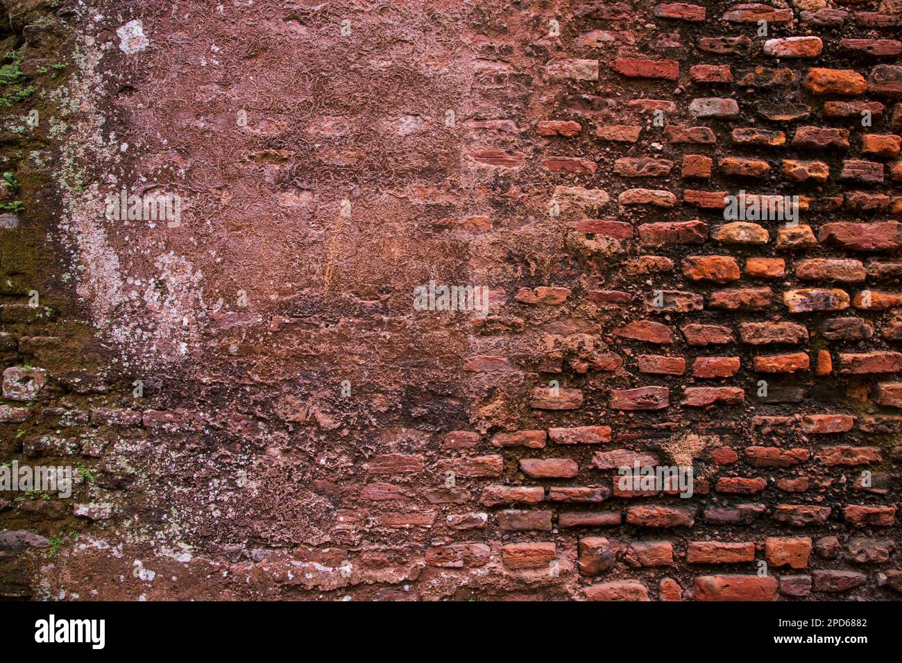 The texture of an old rustic wall is covered with red stucco. Abstract ...