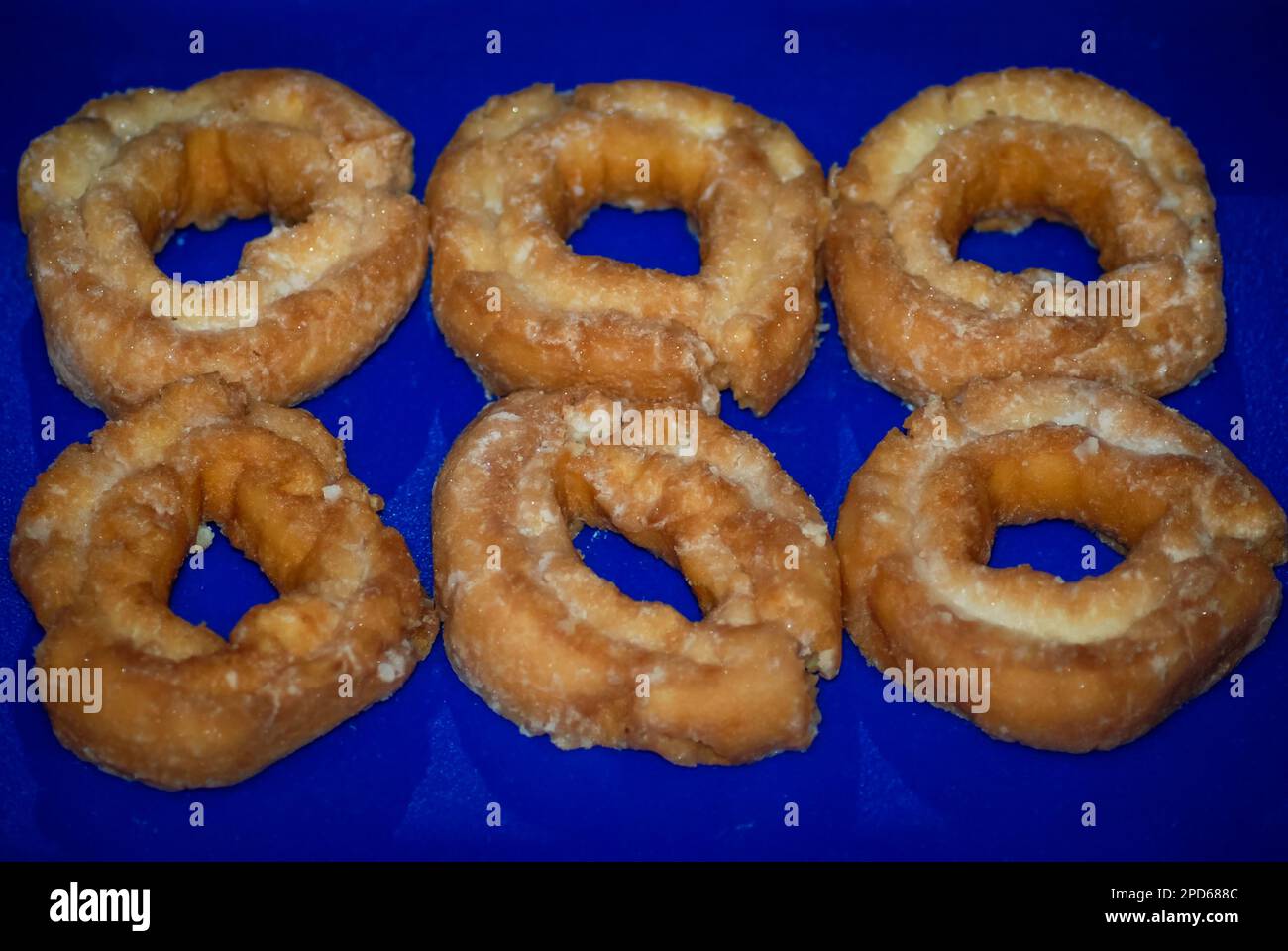 Six doughnuts on a blue background Stock Photo - Alamy