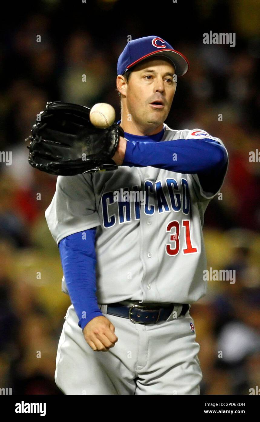 Chicago Cubs pitcher Greg Maddux catches a ball on the mound after ...