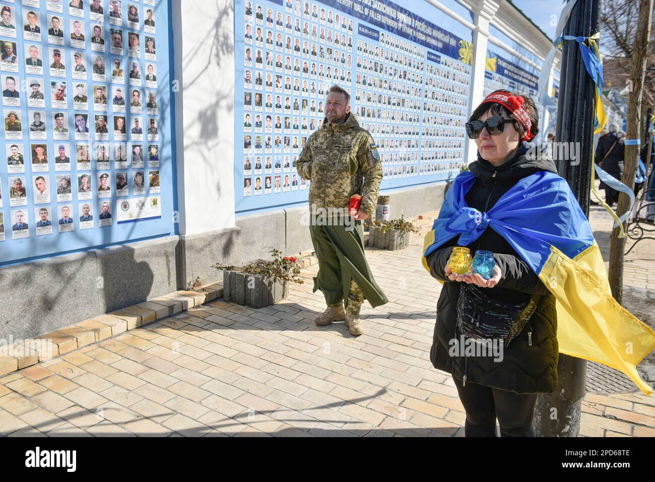 Kyiv, Ukraine. 14th Mar, 2023. A woman draped with a Ukrainian flag ...