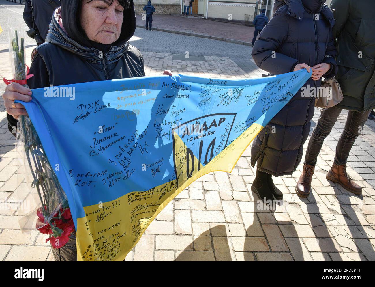 Kyiv, Ukraine. 14th Mar, 2023. A woman holds the flag of the Aidar ...