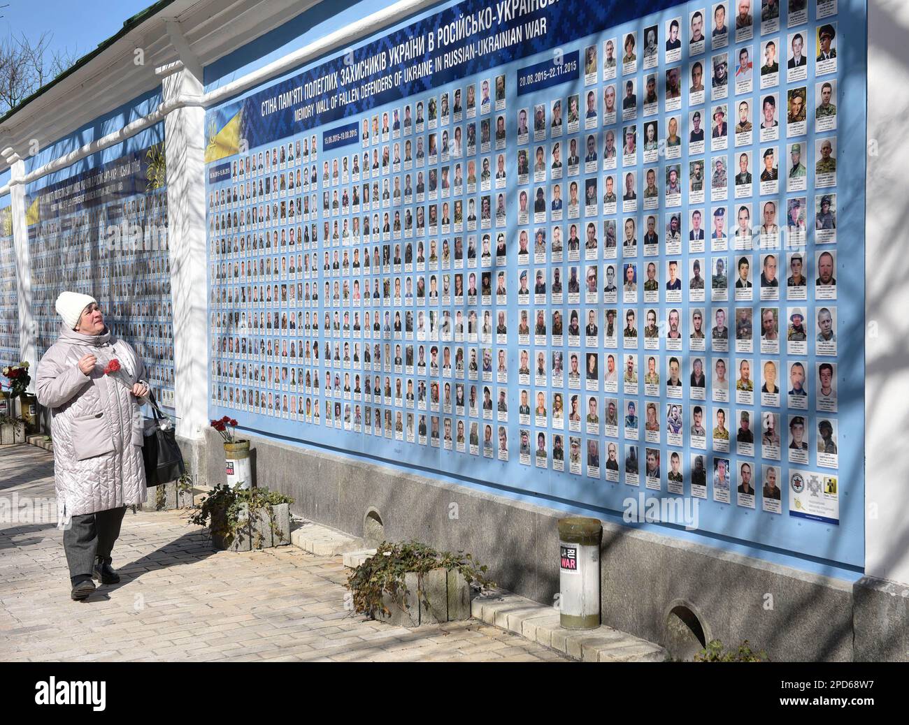 Kyiv, Ukraine. 14th Mar, 2023. A woman puts flowers at the wall of ...